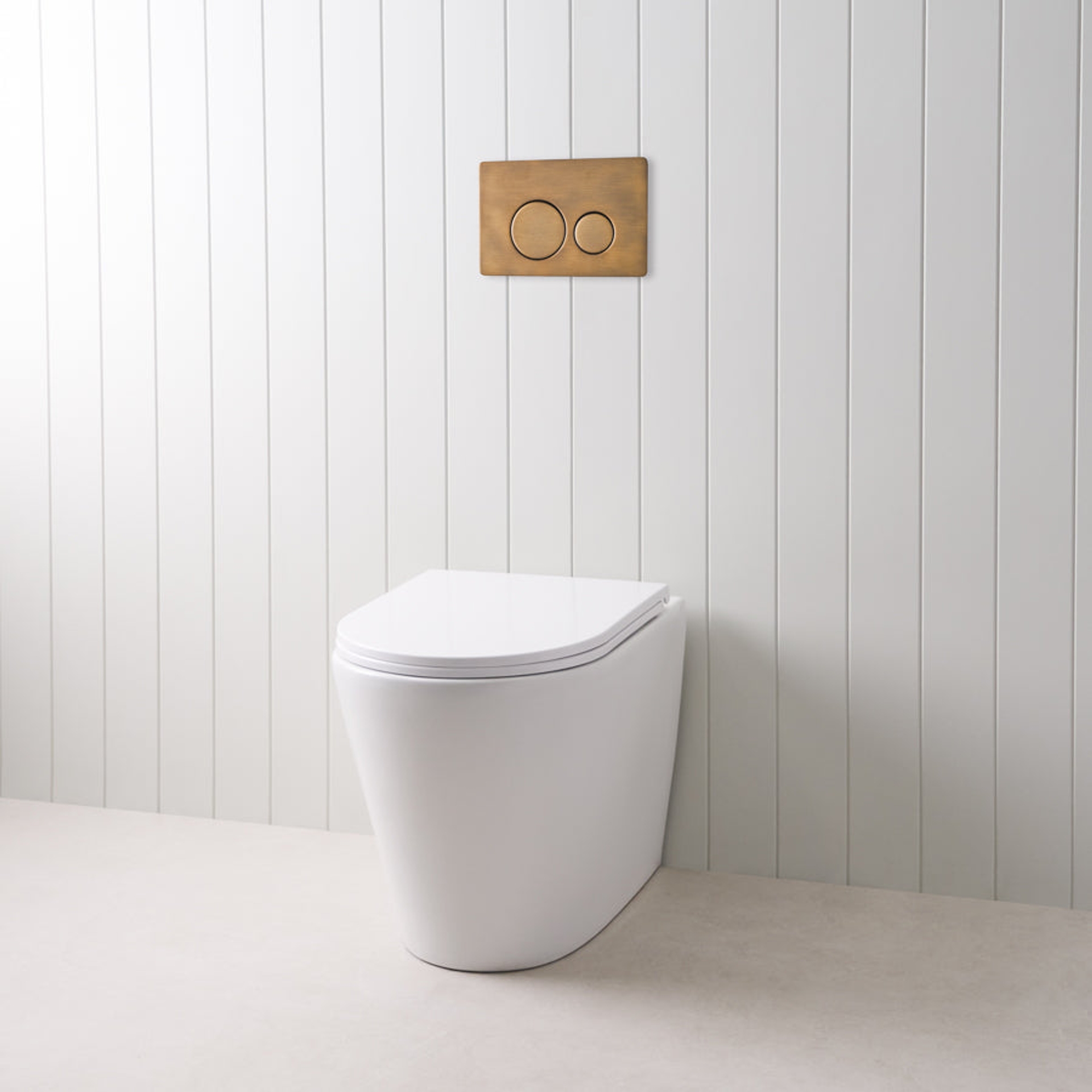 Angled In-Wall Toilet With Round Antique Brass Buttons | TileCloud