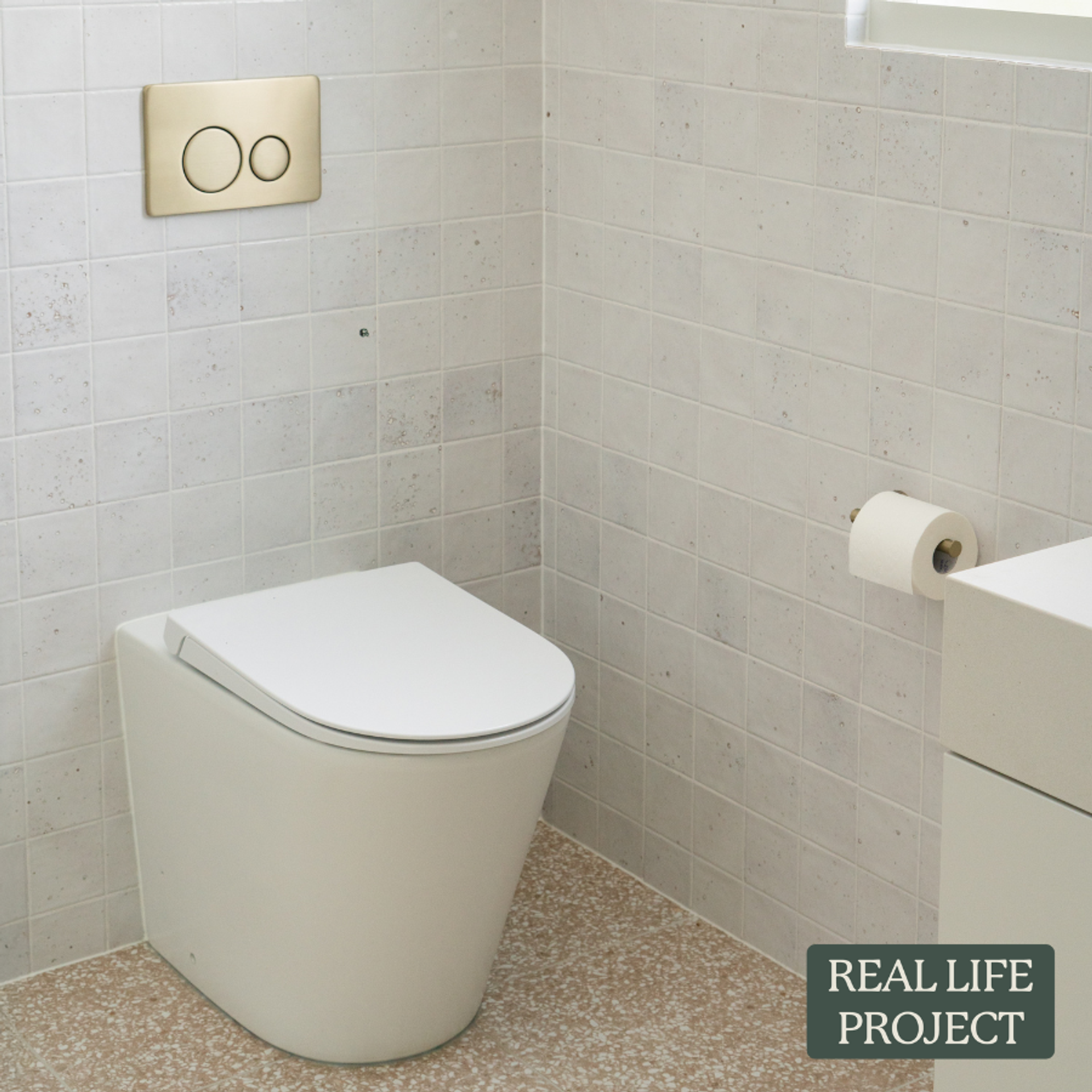 Angled In-Wall Toilet With Round Warm Brushed Nickel Buttons | Yabby