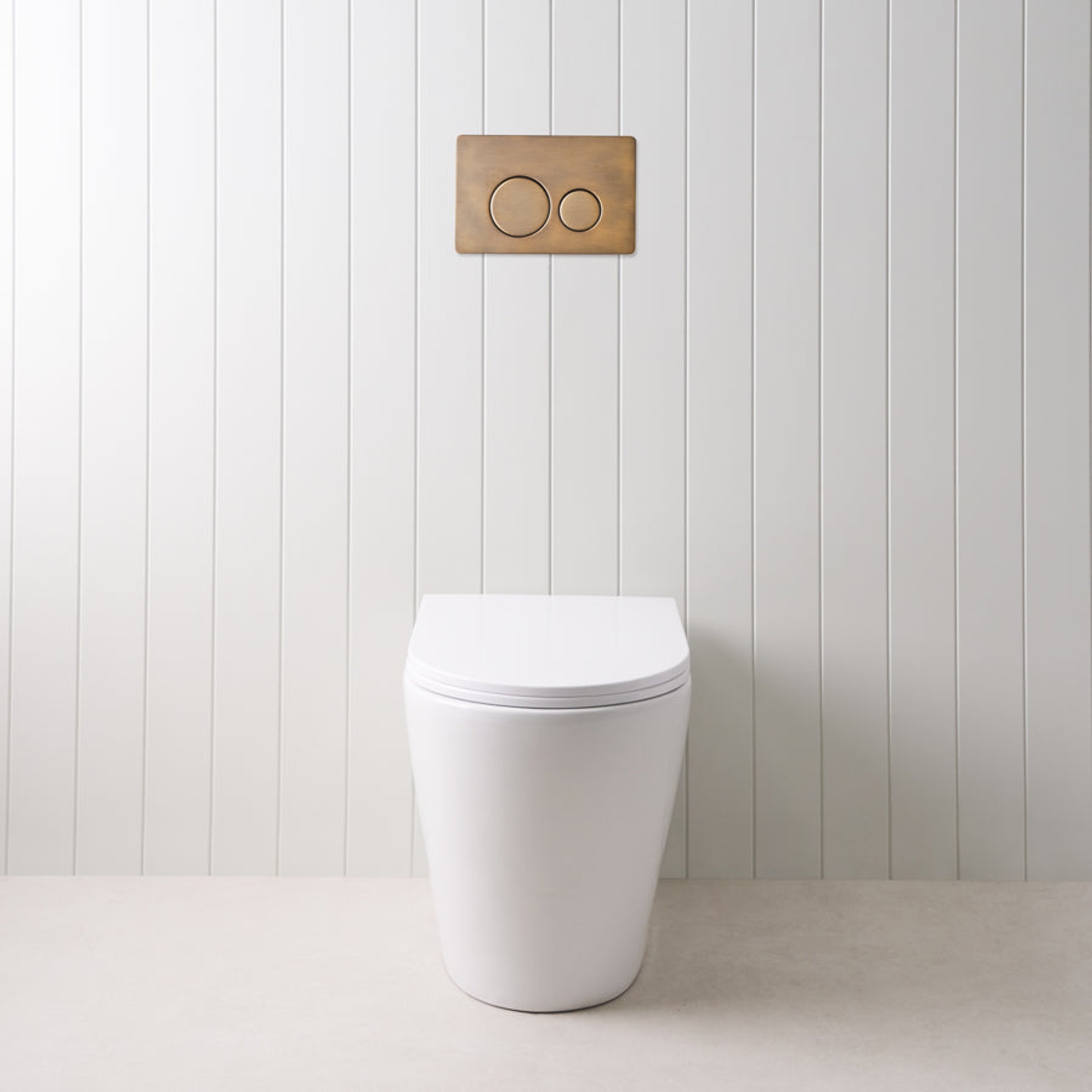 Angled In-Wall Toilet With Round Antique Brass Buttons | TileCloud