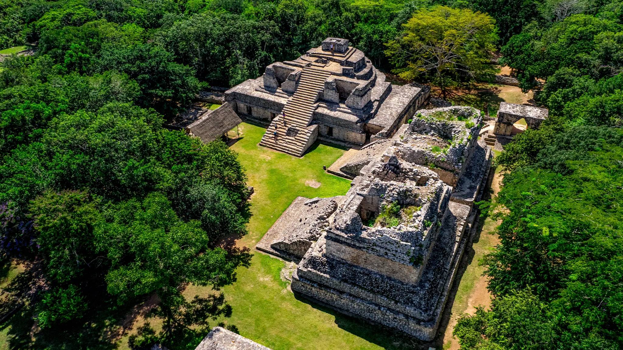 Aerial view of Ek Balam ruins, surrounded by lush vegetation and ...