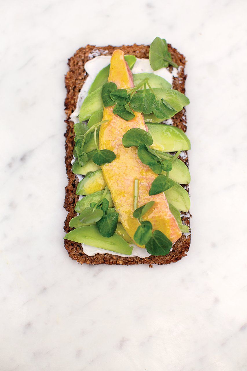 Avocado on rye toast with smoked trout