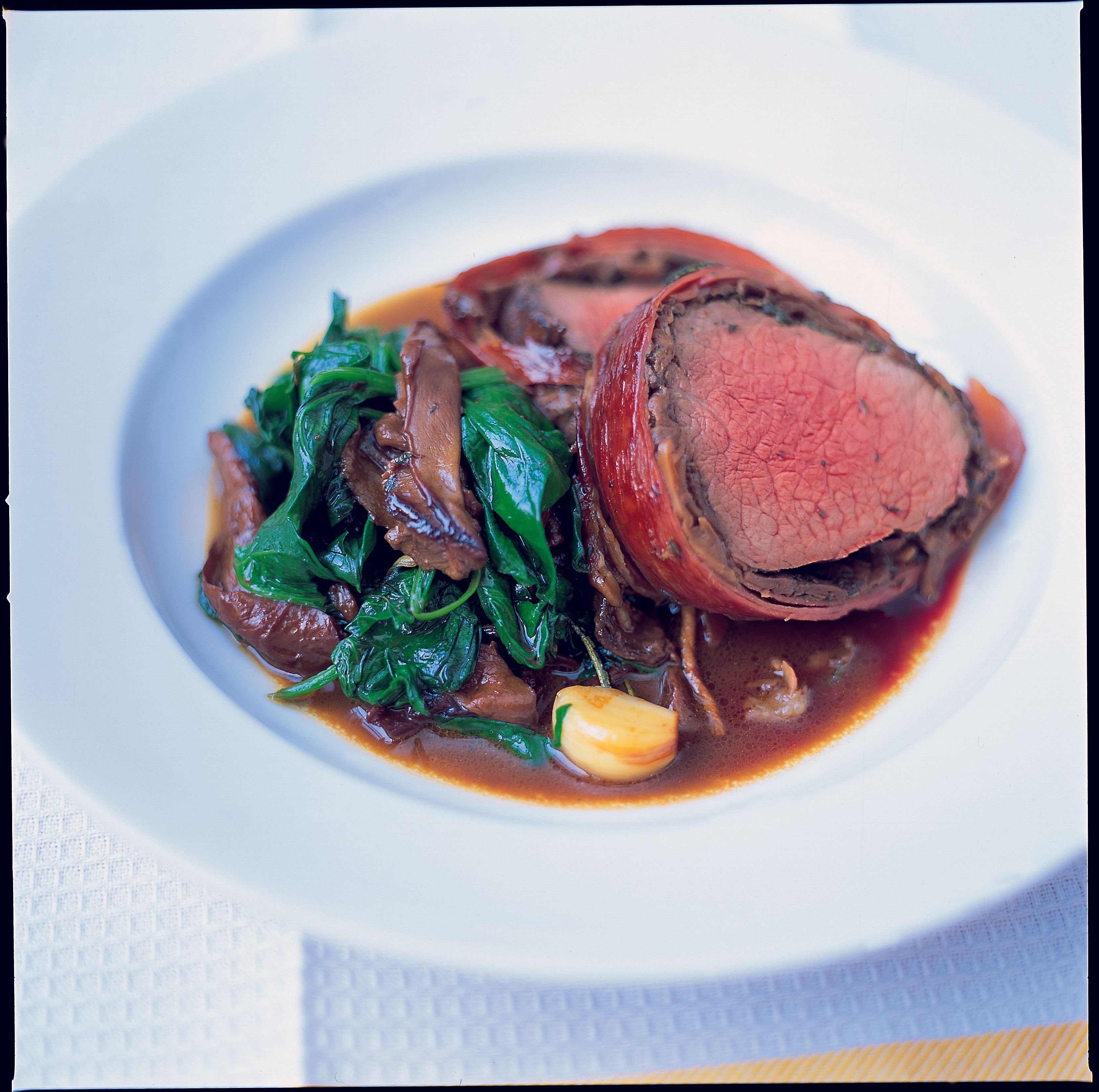 Roasted fillet of beef rolled in herbs & porcini mushrooms & wrapped in ...