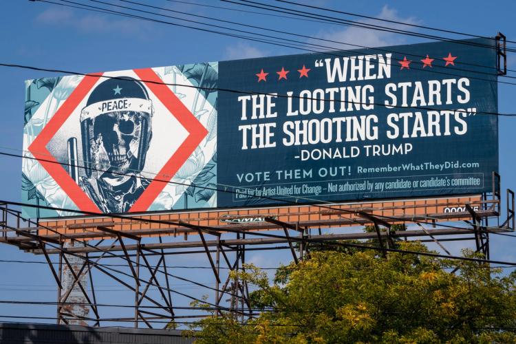 Anti-Trump artist billboards greet presidential candidates in Cleveland