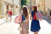 Two women with shopping bags.