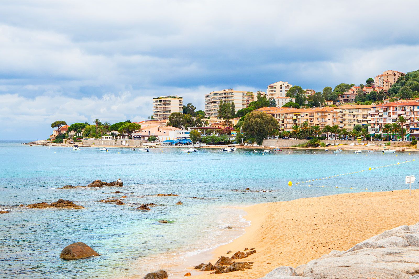 A view of buildings along a shore of a beach.