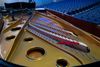A grand piano stands on the stage of the concert hall.