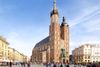 People walk around a market square and large basillica.