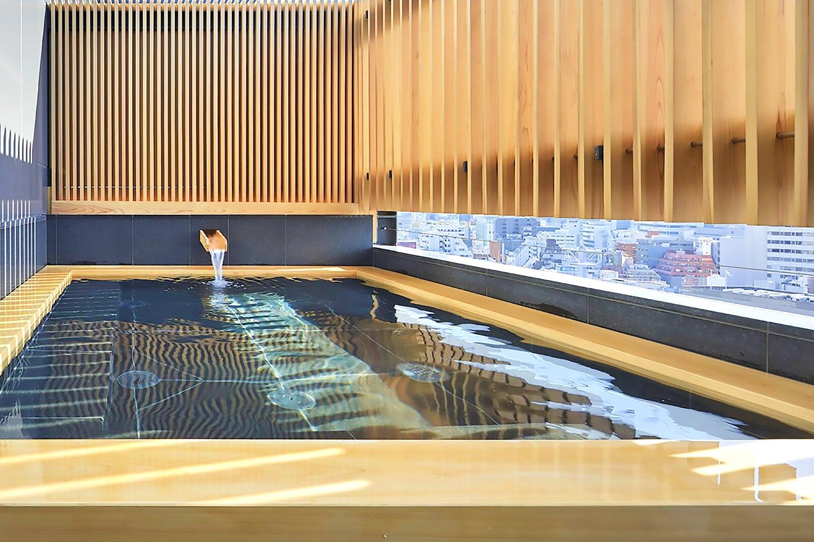 Empty plunge pool overlooking city.