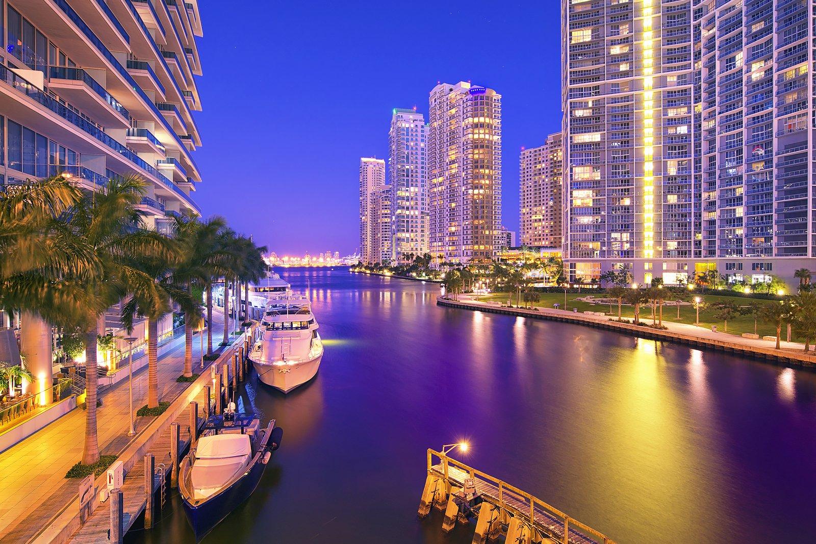 Boats docked in a marina within a city.