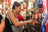 A woman looks at bracelets.