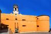 An old brown colored building with blue sky.
