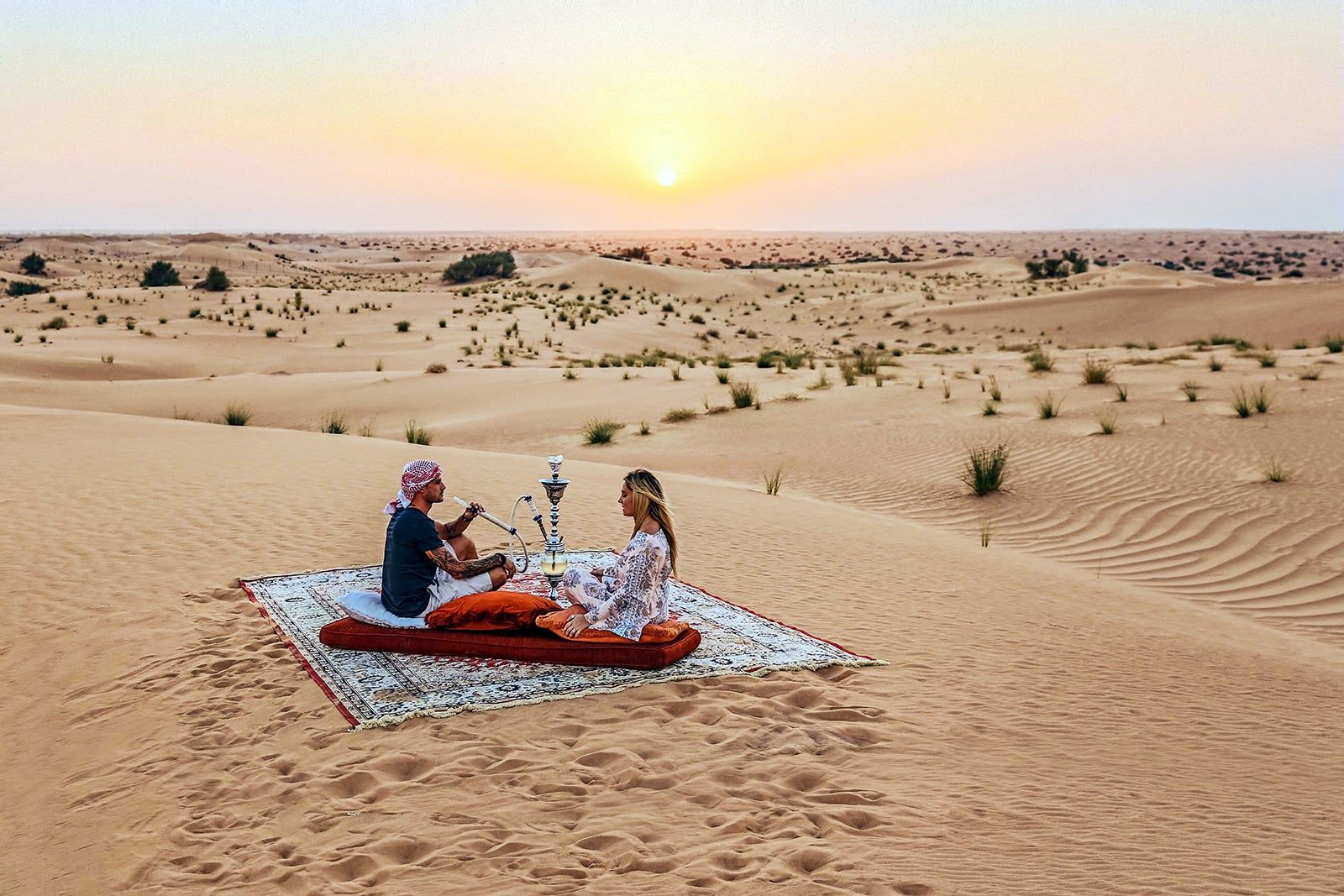A couple spending time on a desert.