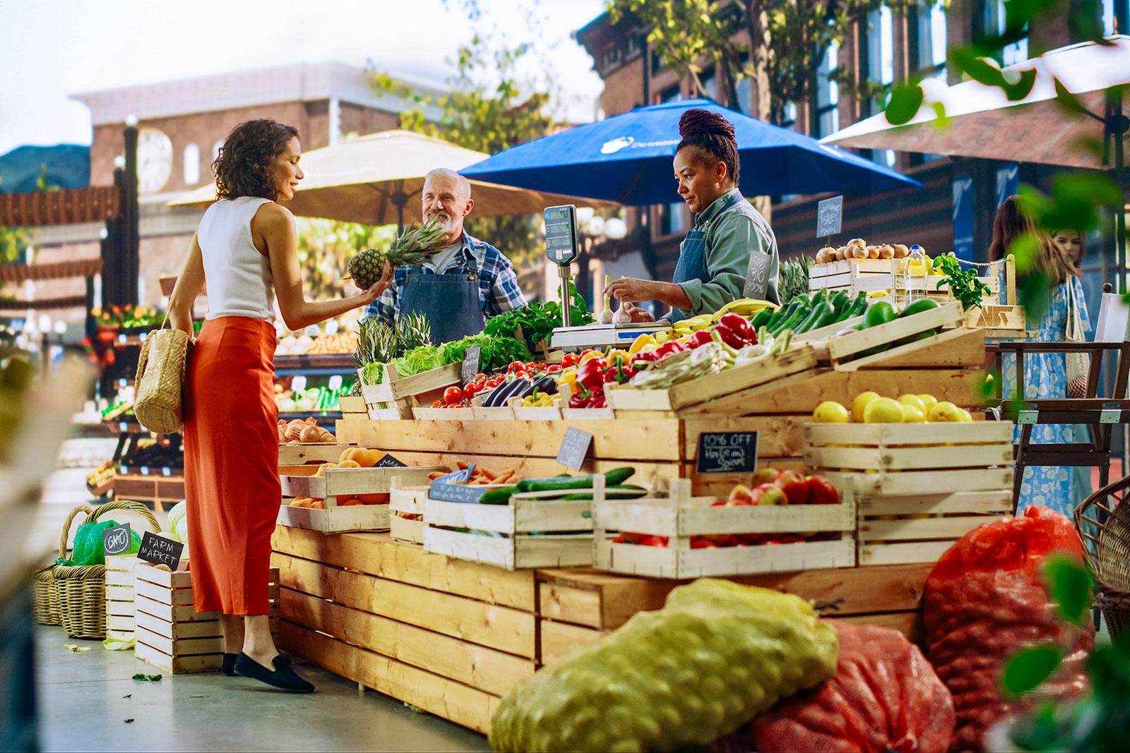 Two women at a farmers market stall.
