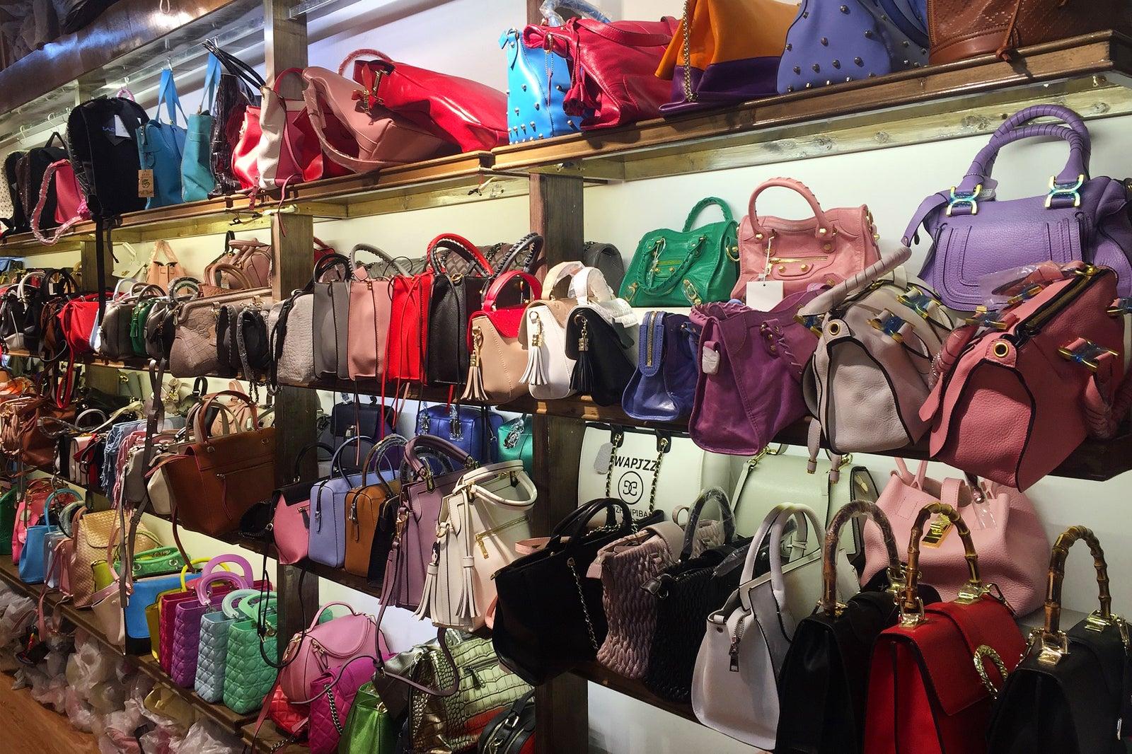 Shelves filled with colorful purses and handbags.