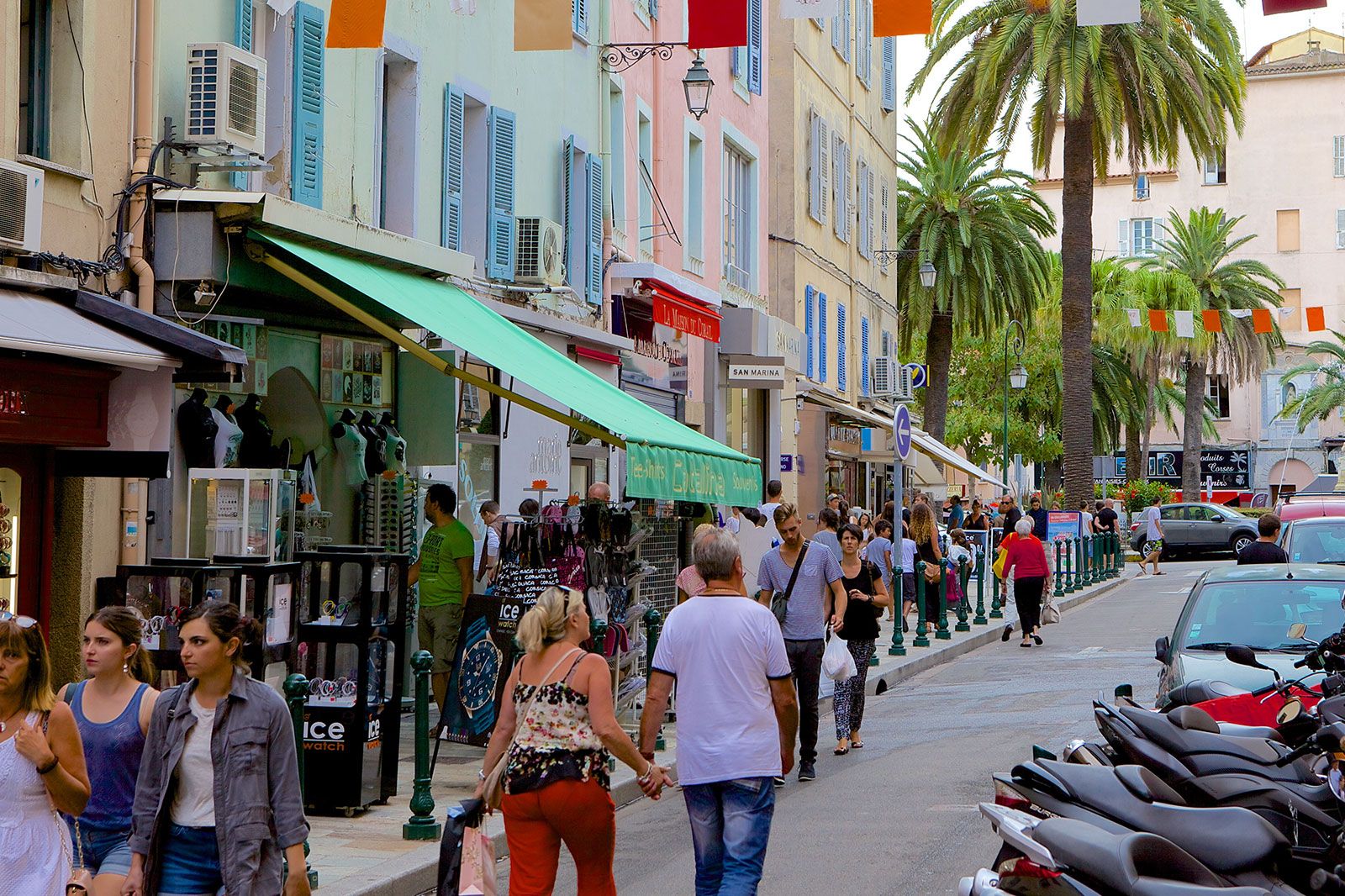 People walk through a city street shopping.
