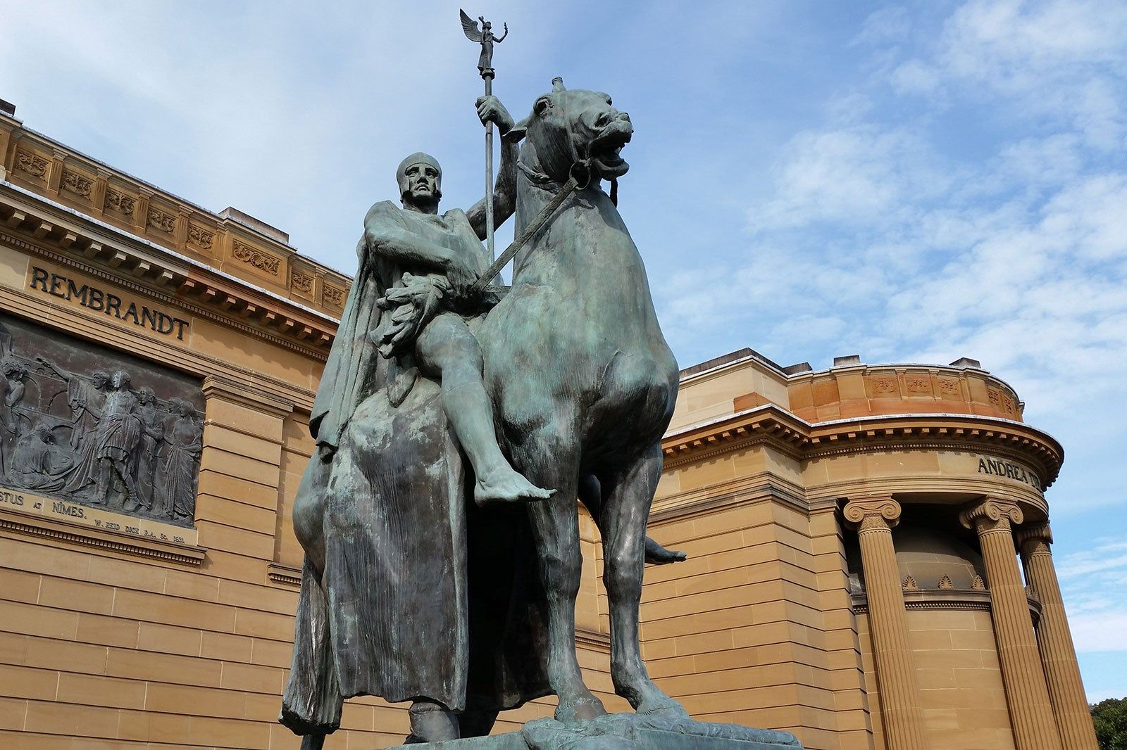 Statue of a man on a horse outside of a museum.