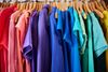 Rainbow colored shirts in a row.