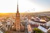Aerial view of an old town at with a chapel tower at sunrise.