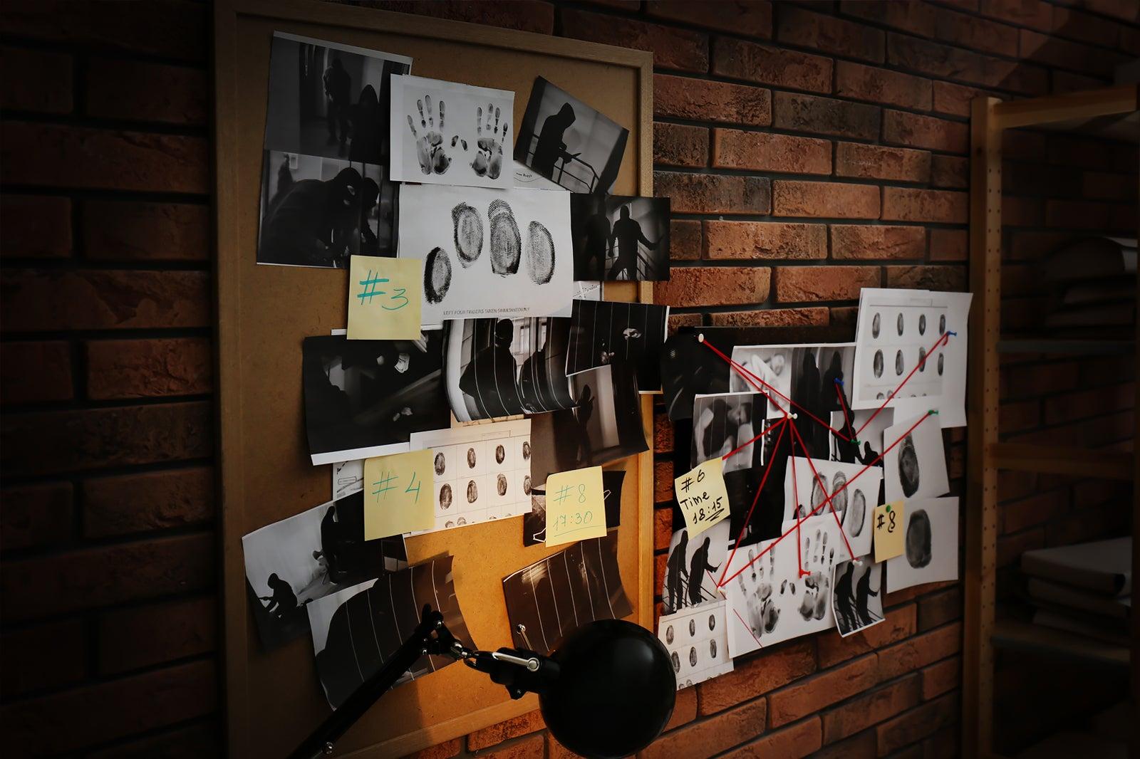 Boards with fingerprints and crime scene photos