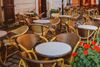 Tables and chairs at an outdoor seating area of a restaurant.