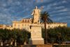 A statue of Bonaparte Napoleon in front of building.