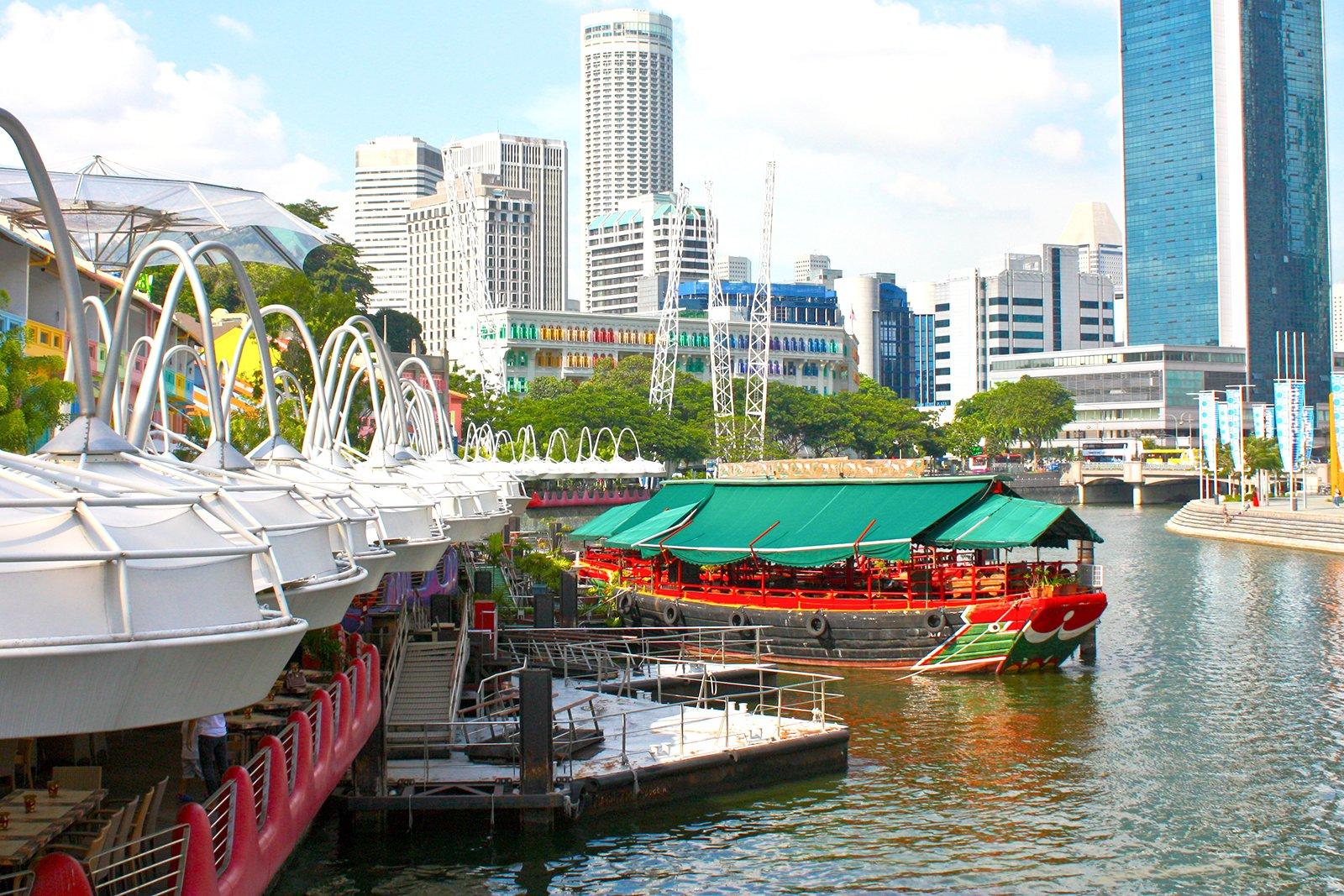 Singapore River and a green-roofed boat.