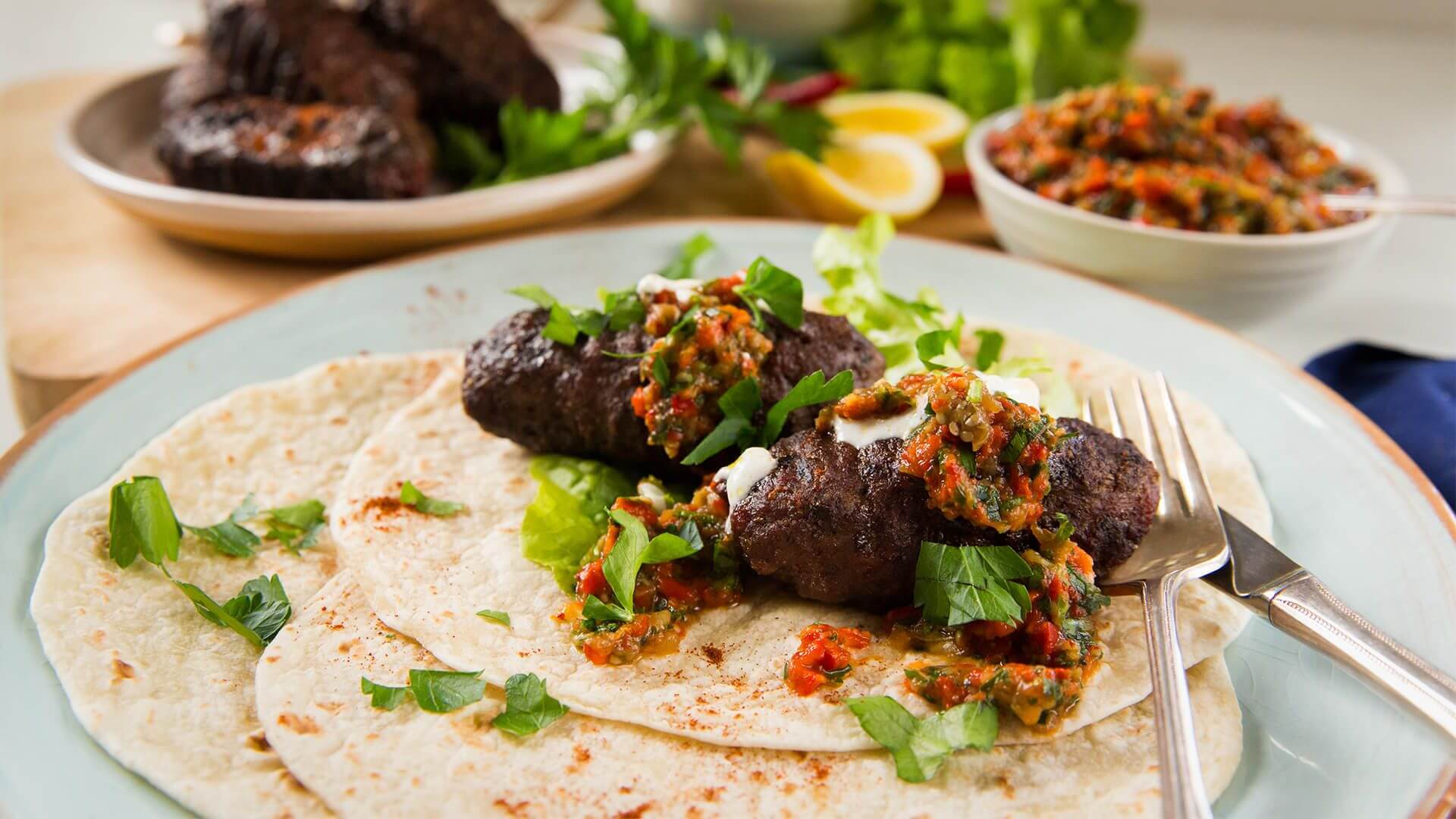 Beef cevapi in flatbread with a sweet red pepper sauce Recipe | Beef ...