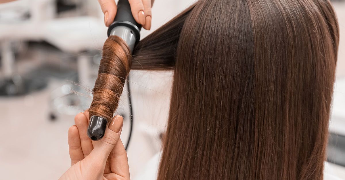 A woman is getting her hair done in a salon.